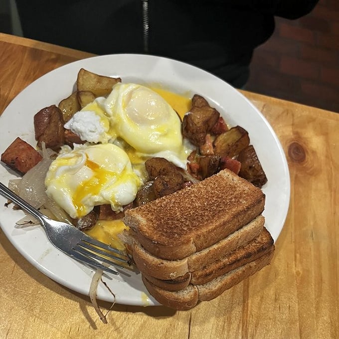 Breakfast alchemy: perfectly poached eggs crowning a mountain of potato-kielbasa hash—proof that Cleveland mornings start with serious flavor.