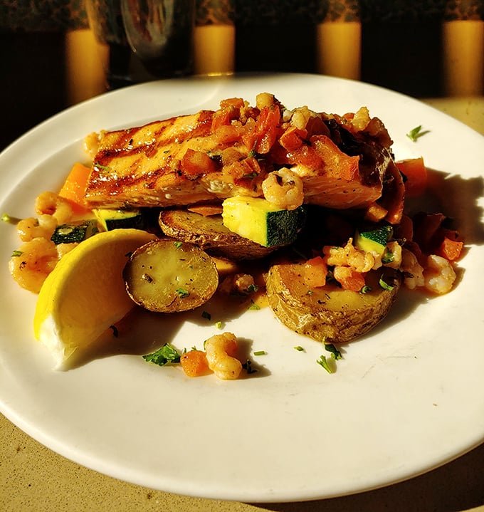 Salmon doesn't get more Oregon than this—perfectly seared and resting on seasonal vegetables like royalty on a colorful throne.