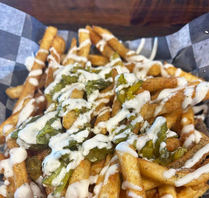 Fries that refused to graduate without honors. The jalapeños and ranch drizzle turn a side dish into the main event.