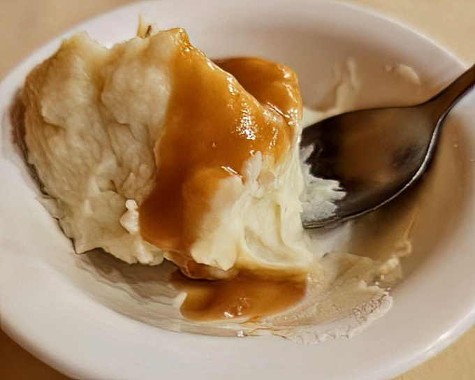 Mashed potatoes with a gravy lake so perfect it deserves its own real estate listing. "Cozy depression with excellent drainage."