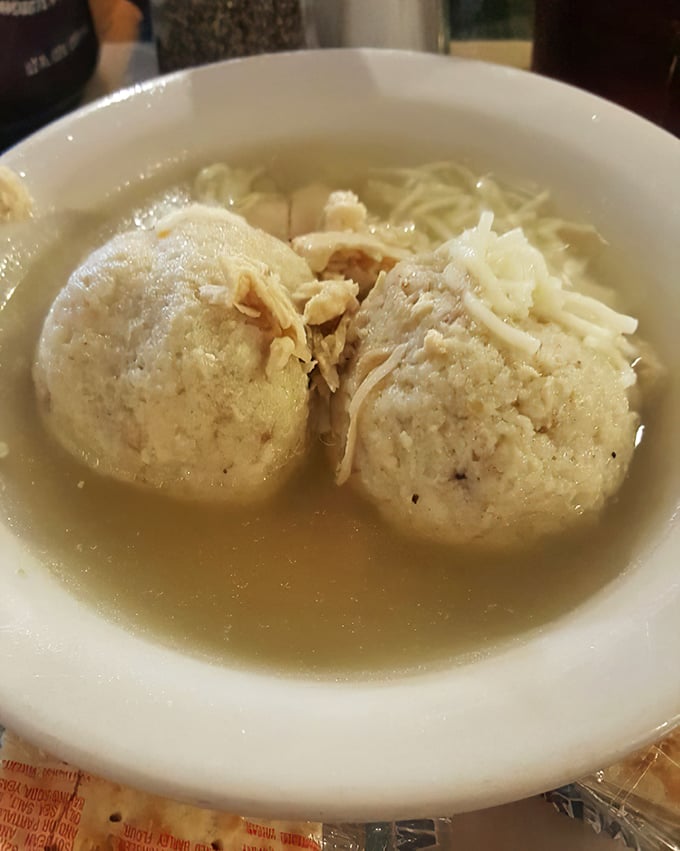 These matzo balls don't sink, they don't float—they achieve that perfect buoyancy in golden broth that Jewish grandmothers have been perfecting for centuries.
