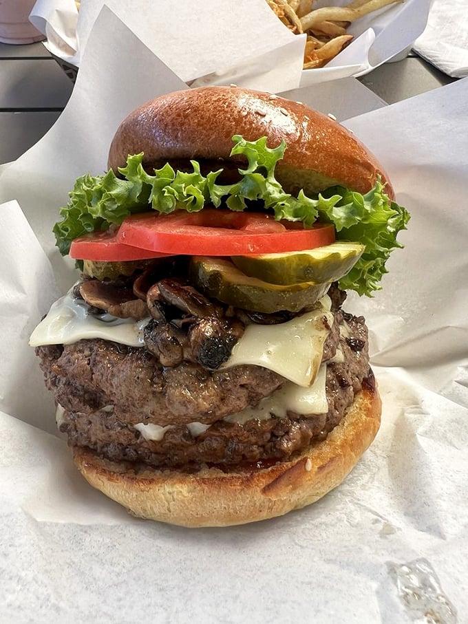 This mushroom-topped masterpiece isn't just a burger—it's architecture with cheese, a skyscraper of satisfaction that requires both hands and focus.