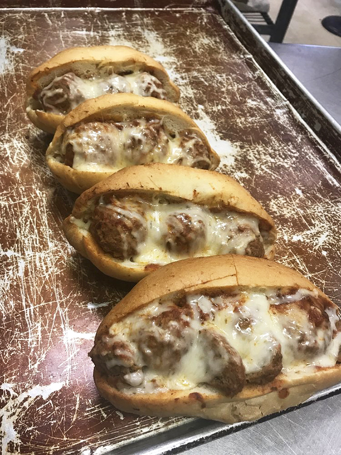 Meatball subs that mean business—tender spheres of seasoned meat nestled in fresh bread and blanketed with melted cheese. Resistance is futile.