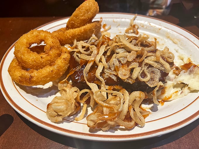 Onion rings and caramelized onions sharing a plate with what appears to be a perfectly cooked steak – proof that the onion is nature's most versatile vegetable.
