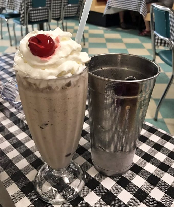The classic milkshake arrives with its own backup plan—that extra metal cup ensuring you get every last creamy drop.