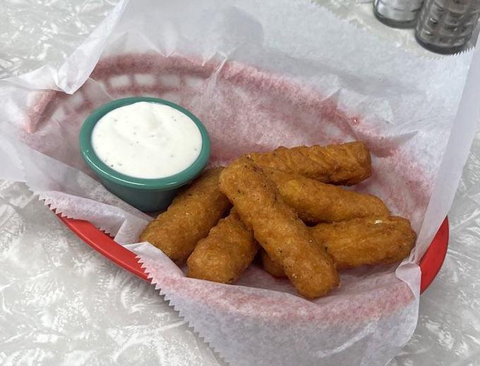 Golden-fried mozzarella sticks: proof that sometimes the simplest pleasures are the most profound. That dipping sauce is calling your name. 
