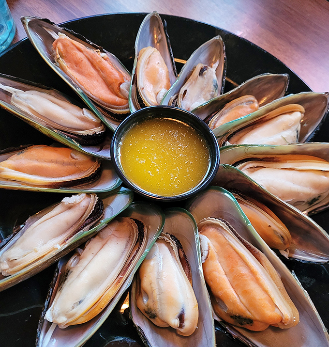 Ocean treasures arranged like a sunburst around liquid gold butter—these mussels aren't just seafood, they're an event.