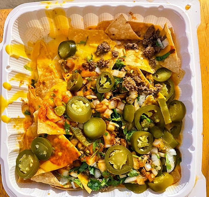 Nachos that laugh at sports stadium versions – loaded with jalapeños, cheese, and meat in a symphony of textures that would make Mozart weep.