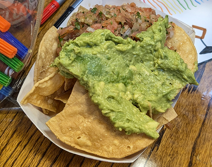 Guacamole mountain meets chip valley in this simple yet spectacular nacho plate—proof that sometimes the classics need no improvement.