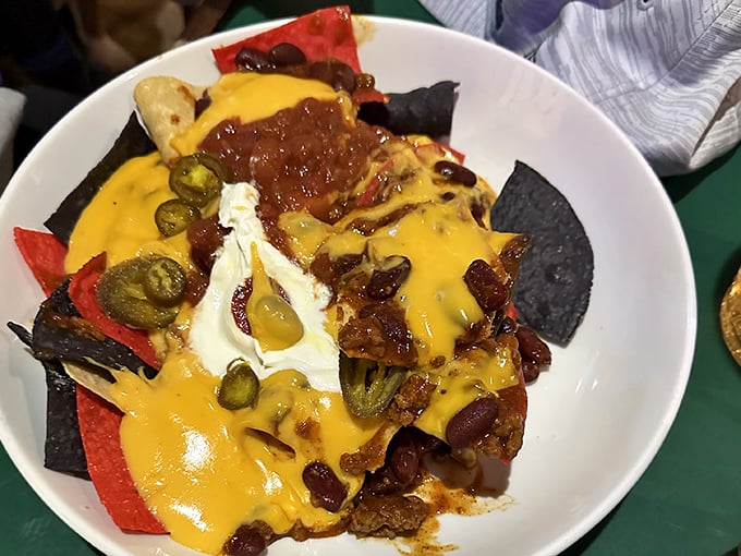 These nachos aren't just a snack, they're an architectural achievement – layers of flavor supporting a delicious cheese-covered democracy. 