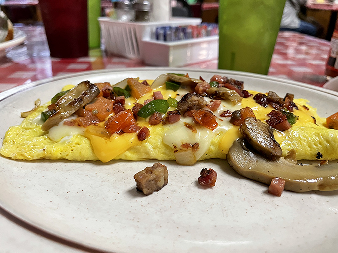 An omelet that doesn't just contain ingredients—it celebrates them. Mushrooms, peppers, and cheese performing a morning symphony on your plate.
