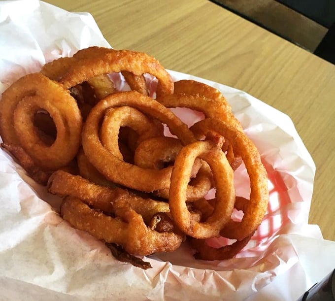 Onion rings that deserve their own fan club. Crispy, substantial, and demanding to be devoured one glorious circle at a time.