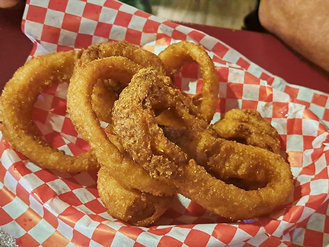Golden-brown onion rings stacked like edible jewelry—crispy, light, and the perfect vehicle for whatever sauce catches your fancy.