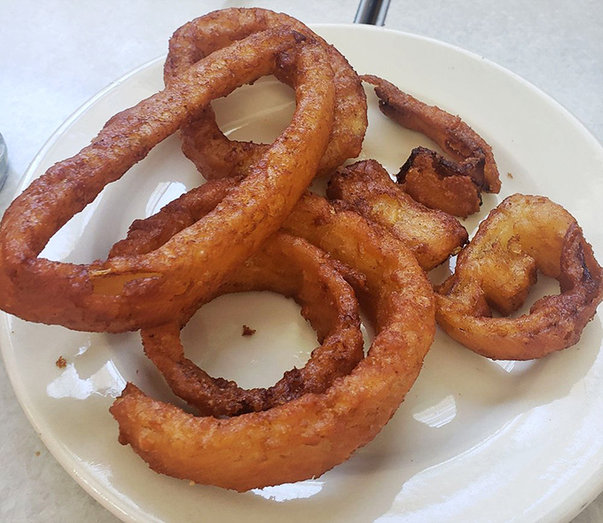 These onion rings aren't just side dishes—they're golden halos of crunch that make you question why you ever settled for lesser versions.
