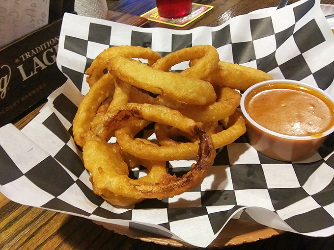 Onion rings so perfectly golden and substantial they deserve their own area code, served with a dipping sauce that demands to be sampled.