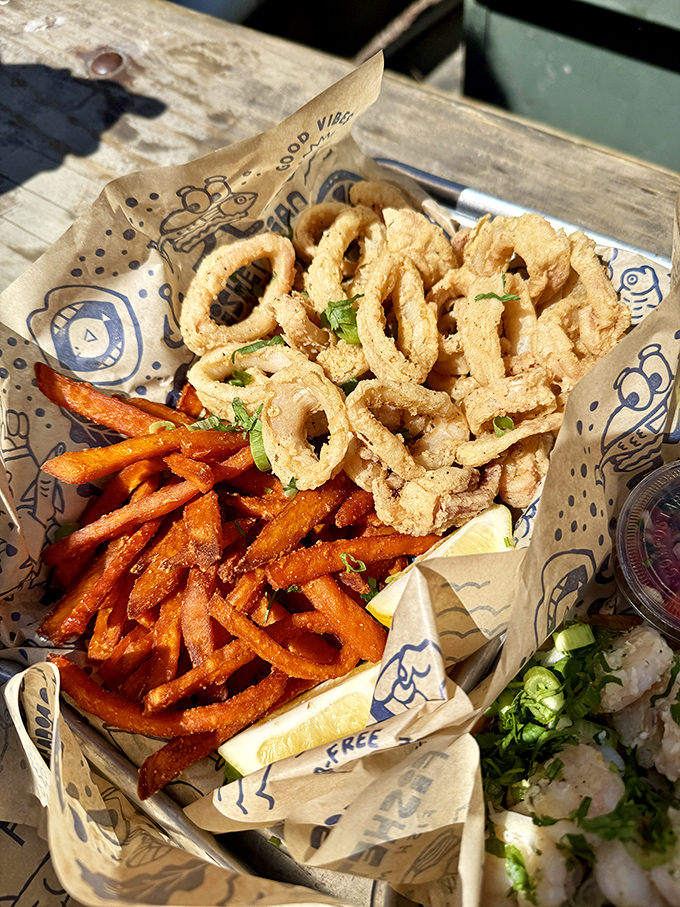 A seafood trio that hits all the right notes—crispy calamari, sweet potato fries, and something fresh that makes you feel slightly virtuous while indulging.