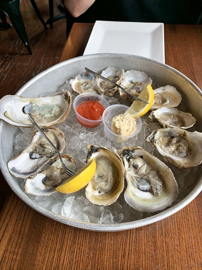 These oysters aren't just served, they're presented—a glistening dozen on ice that whispers tales of distant tides and briny perfection.