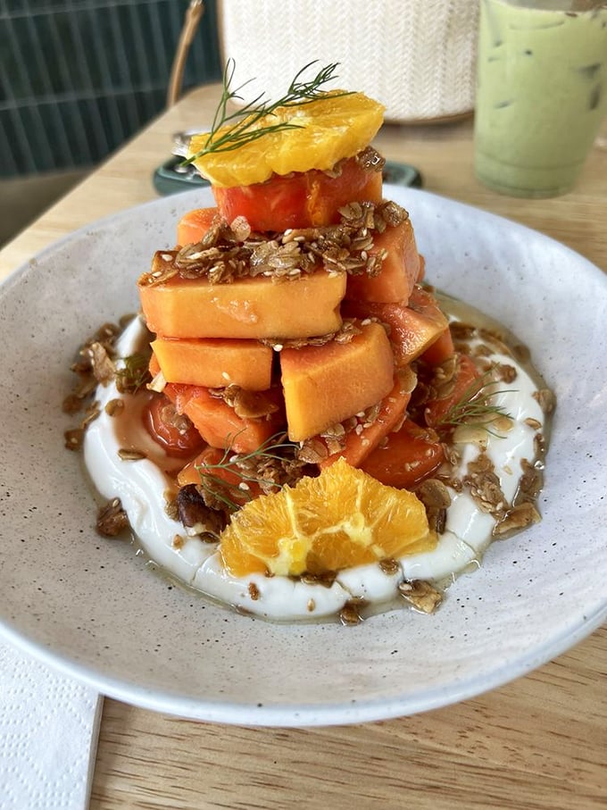 Papaya transformed into an architectural marvel. This isn't just fruit – it's a sweet, tangy revelation balanced atop yogurt like nature's most delicious Jenga game.