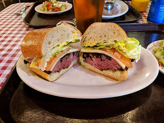 A sandwich artist's dream canvas—pastrami sliced so perfectly it makes you wonder if they hired a geometry professor to man the slicer.