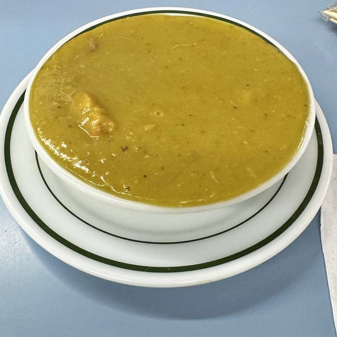 The pea soup looks like liquid sunshine and tastes like comfort – the kind that makes you forget about fancy bisques forever.