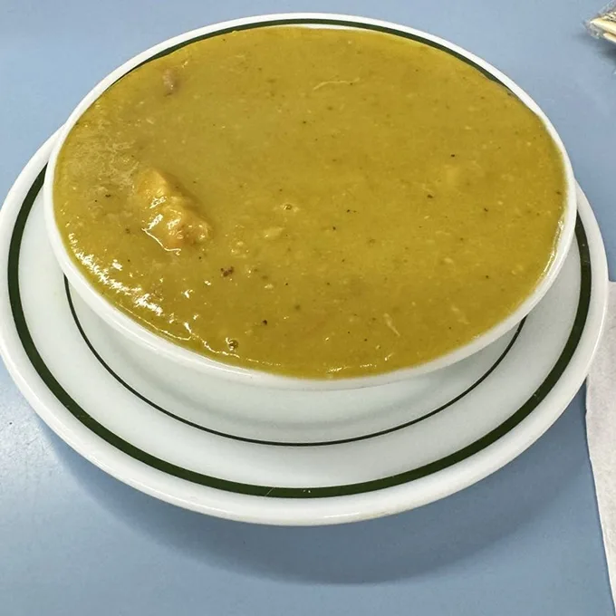 The pea soup looks like liquid sunshine and tastes like comfort – the kind that makes you forget about fancy bisques forever.