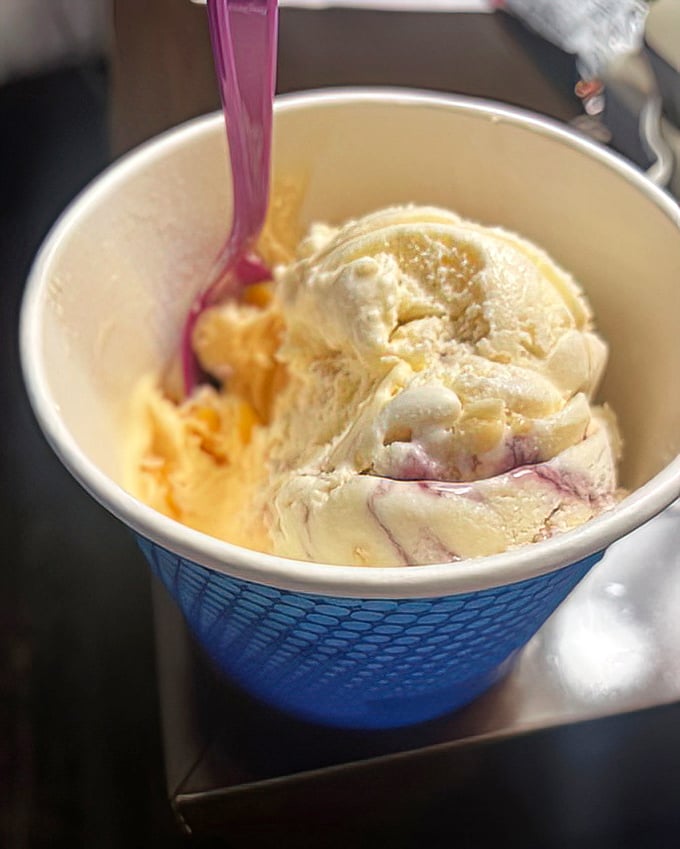 Swirls of creamy goodness that capture summer in every spoonful. That purple ribbon isn't just color—it's flavor performing a ballet on your taste buds.