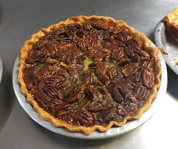 Pecan pie that glistens with promise—each nut perfectly arranged like nature's mosaic atop a filling that strikes the ideal balance between sweet and rich.