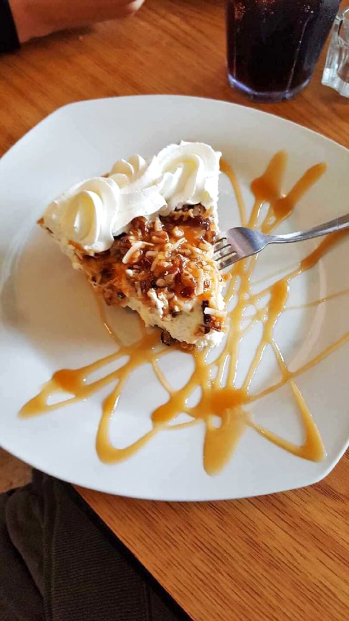 Pecan pie drizzled with caramel that would make your grandmother both jealous and proud. The whipped cream isn't just a topping—it's the cloud this slice of heaven floats on.