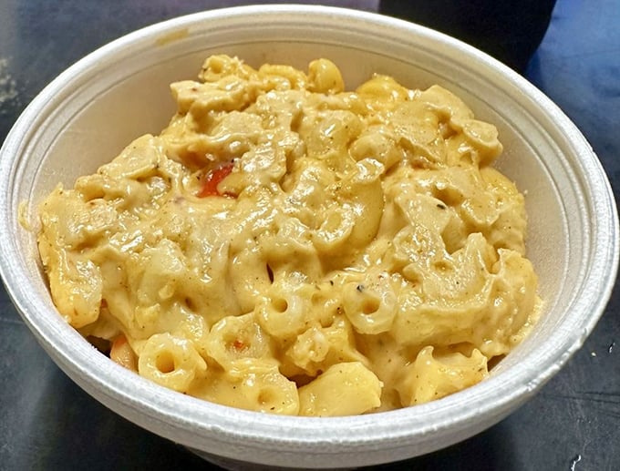 Mac and cheese that doesn't just accompany hot chicken—it rescues you from it. Creamy, cheesy salvation in a simple white bowl.