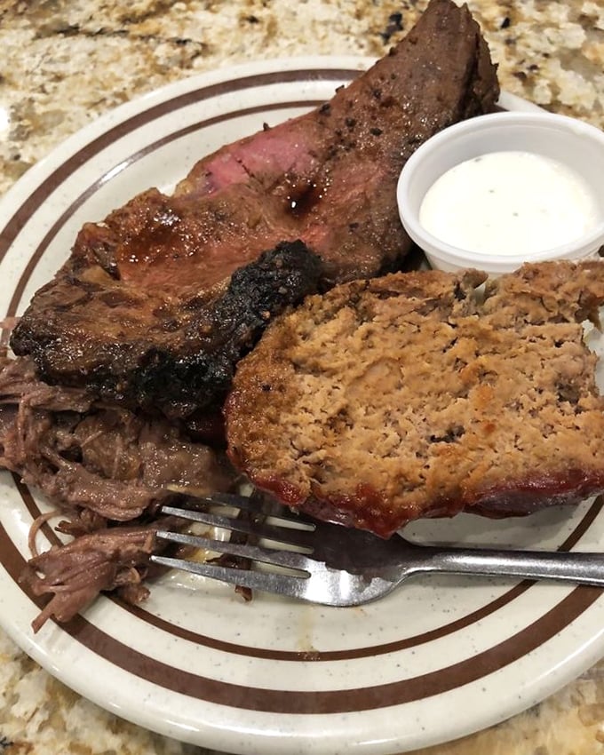 The holy trinity of comfort food: tender pot roast, perfectly pink in the middle, alongside hearty meatloaf and a side of creamy sauce.