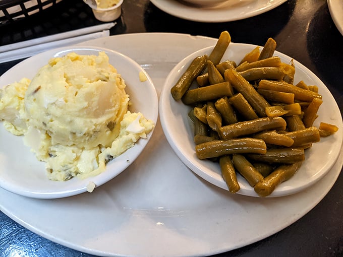 Comfort food poetry: creamy potato salad alongside green beans cooked the way Grandma intended—soft, savory, and unapologetically Southern.