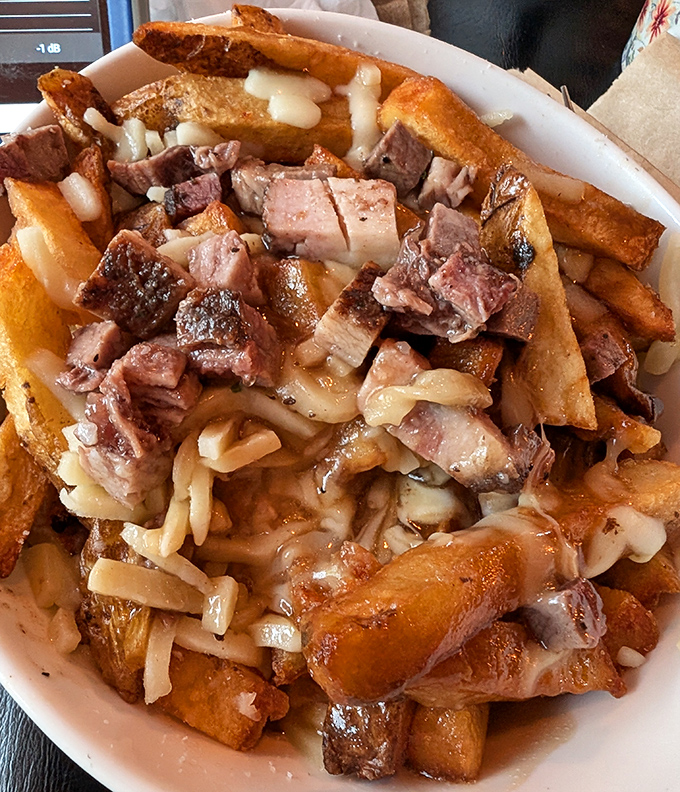 Poutine that would make Canadians nod in approval – crispy fries swimming in gravy and topped with savory brisket that melts faster than winter in Ohio.