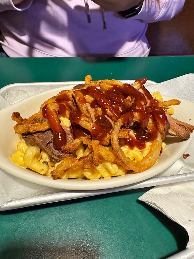Mac and cheese topped with tender beef and crispy onion strings—proof that sometimes the best comfort foods are the ones that join forces.