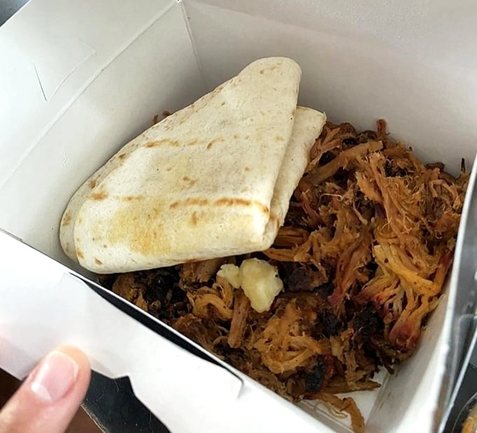 Pulled pork perfection nestled beside a warm tortilla—a beautiful relationship that proves some of the best partnerships are the simplest ones.