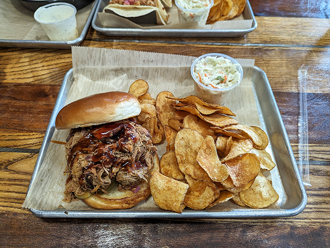 Pulled pork that's had a proper Southern upbringing – tender, saucy, and served with house-made chips that shatter satisfyingly with each bite.