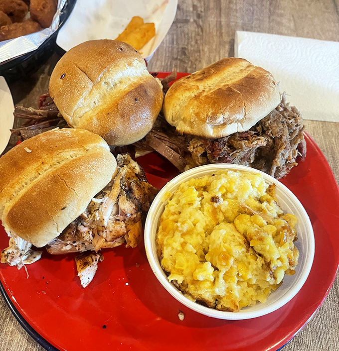 Pulled pork sandwiches piled so high they require strategic planning before the first bite. The mac and cheese isn't asking for attention—it's demanding it.