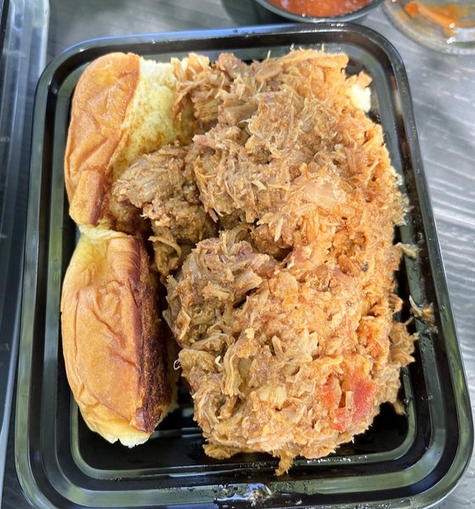 The pulled pork sandwich – where tender, smoky meat meets fresh roll in a relationship so perfect it should have its own reality show.