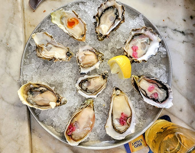 A dozen glistening oysters on ice – nature's perfect appetizer. Each shell contains a tiny ocean of flavor waiting to be discovered.