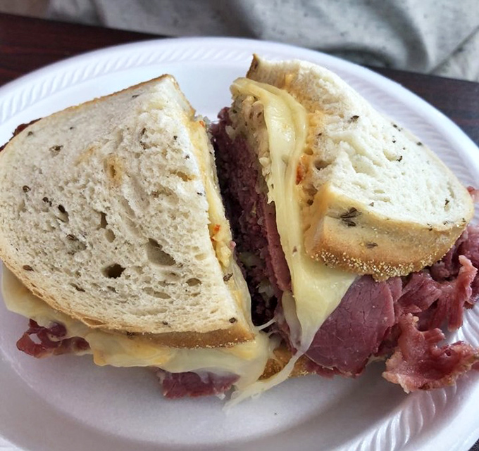 The legendary Reuben in all its glory—corned beef sliced to perfection, Swiss cheese melted just right, and that magical balance of sauerkraut and Russian dressing.