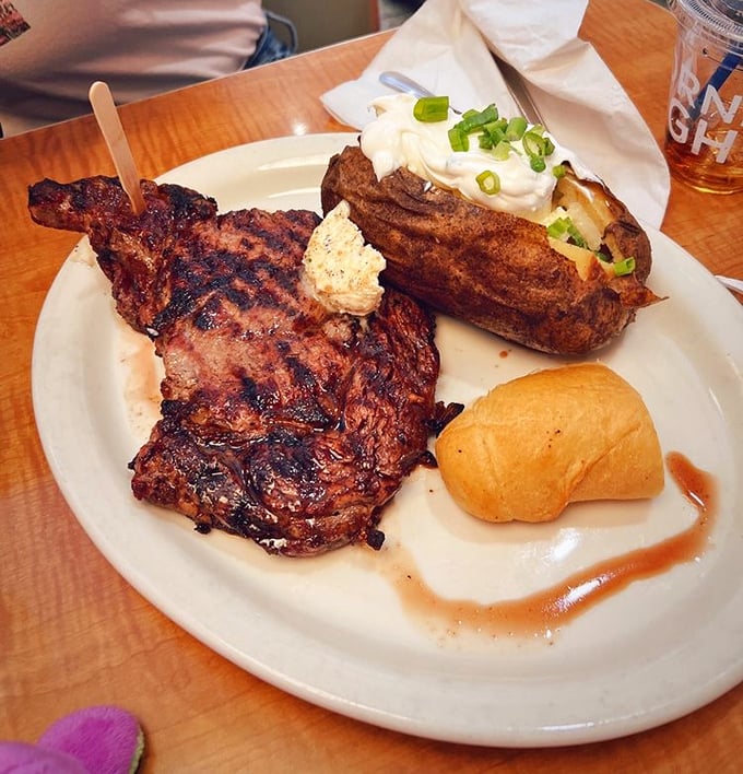 This isn't just a steak—it's what cowboys dream about after a long day on the range. That loaded baked potato is playing a delicious supporting role.