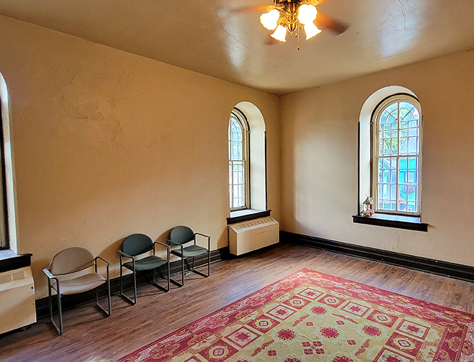 A surprisingly peaceful room within prison walls. The windows let in light but little hope—architectural poetry in the most tragic sense.