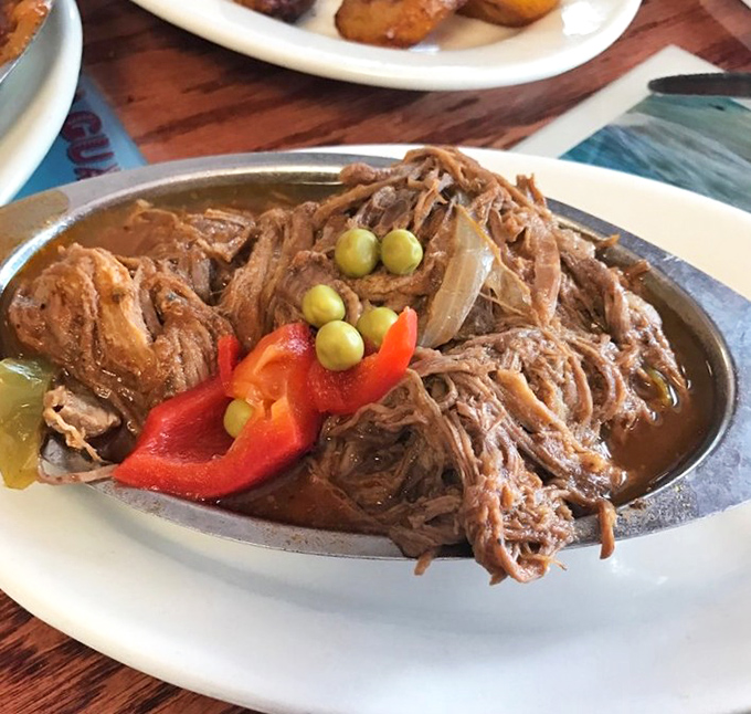 Ropa Vieja—literally "old clothes"—but there's nothing threadbare about this succulent shredded beef adorned with peppers like confetti at a flavor parade.