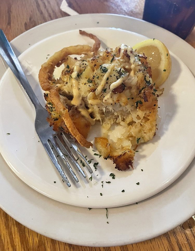 This crab cake isn't hiding behind fillers—it's the seafood equivalent of a Hollywood star who refuses a stunt double.