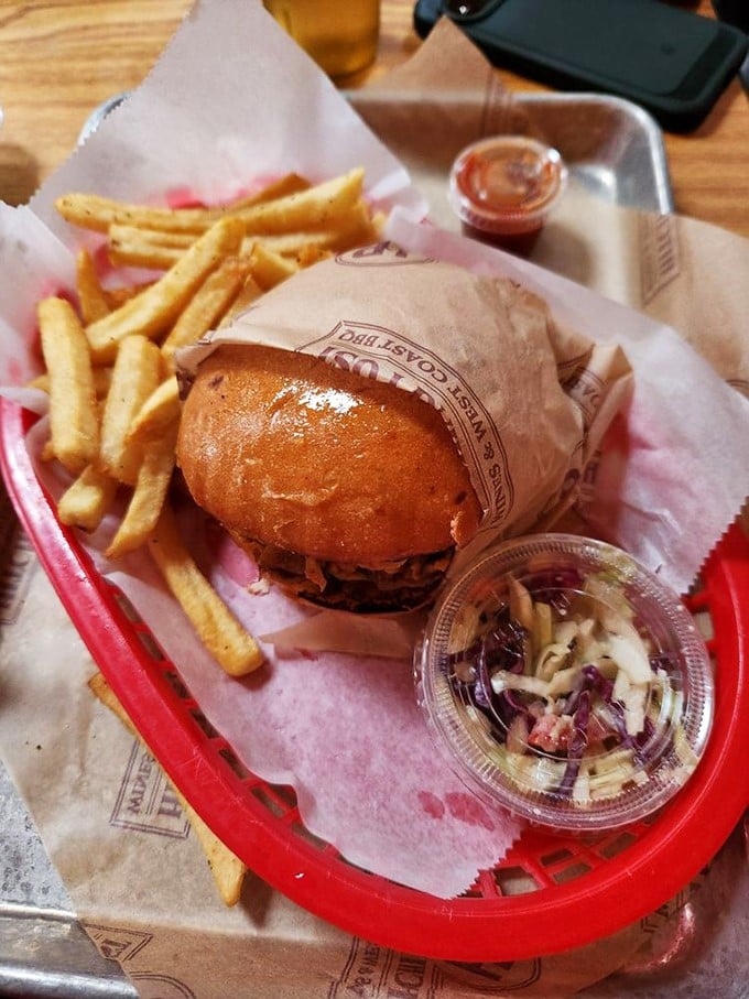 Not just a sandwich, but a handheld masterpiece of BBQ craftsmanship. Those fries aren't sidekicks—they're co-stars in this delicious production.