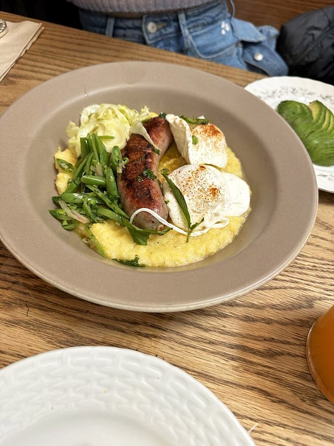 Creamy polenta cradles perfectly cooked sausage and eggs – comfort food that would make your Italian grandmother weep with joy.