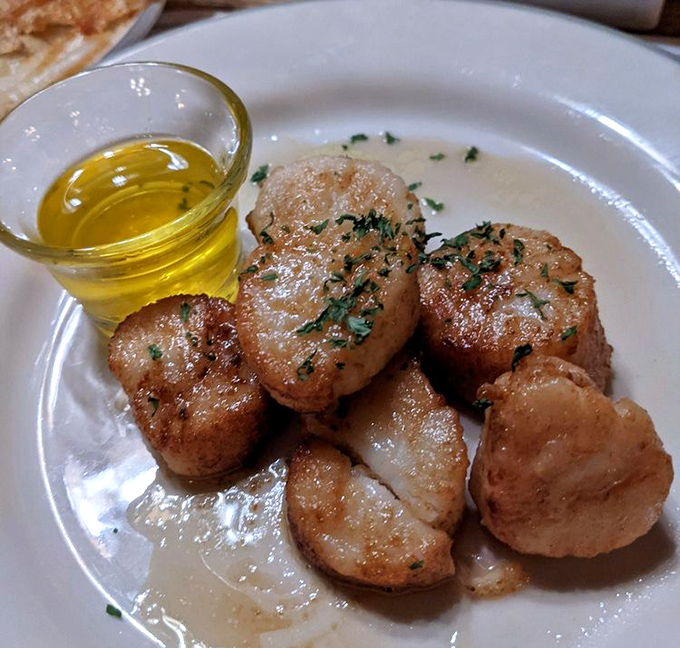 These sea scallops are caramelized to golden perfection—like little butter-kissed treasures from Neptune himself. The drawn butter is just showing off.