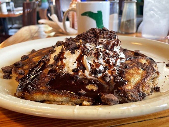 Chocolate chip pancakes that would make Willy Wonka jealous. The whipped cream hat isn't optional—it's essential to the experience.