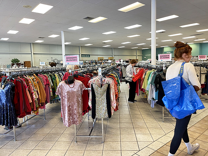 Serious shoppers navigate the well-organized women's section with the focus of archaeologists on the brink of a major discovery.