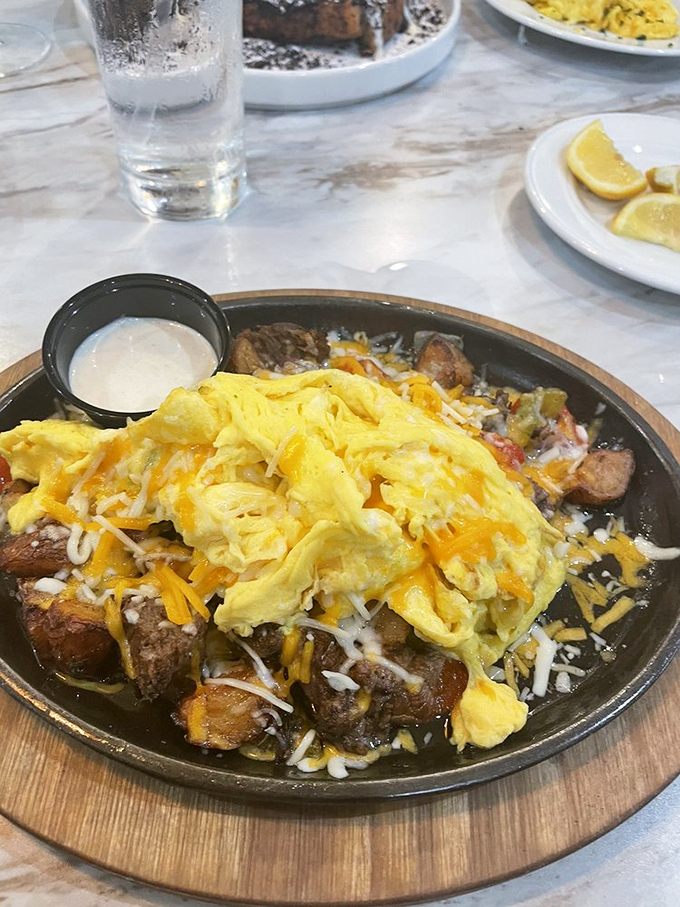 Breakfast gets serious with this short rib skillet—where fluffy eggs and melted cheese meet savory beef in a morning romance that's worth setting the alarm for.