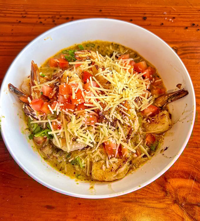 Shrimp and grits: the South's greatest contribution to comfort food. This bowl of creamy goodness topped with fresh tomatoes and cheese is pure Florida soul.